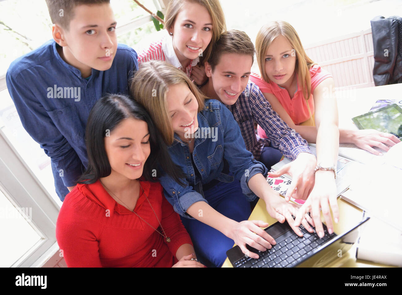 happy young teens group in school have fun an learning lessons Stock ...