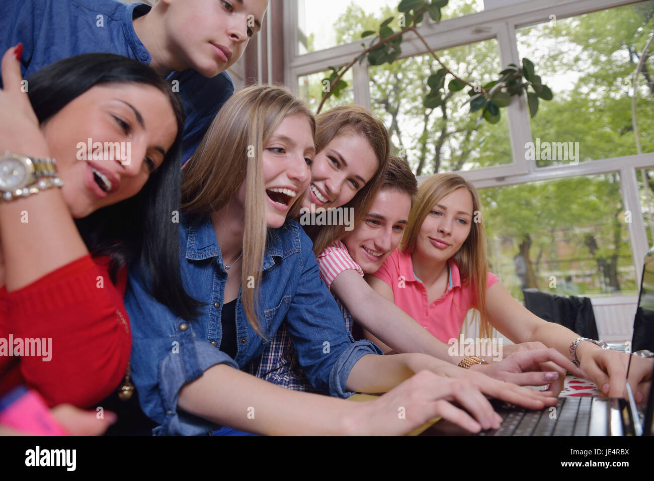 happy young teens group in school have fun an learning lessons Stock ...