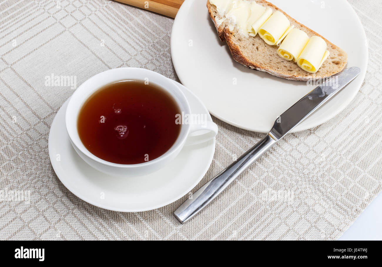 cup of black tea with a sandwich for breakfast Stock Photo - Alamy