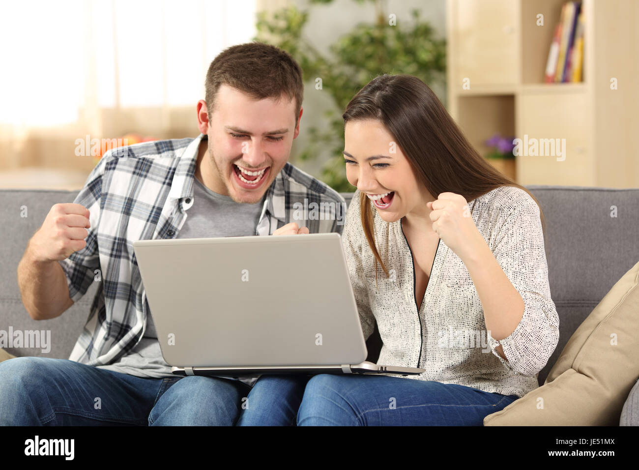 Couple excited laptop hi-res stock photography and images - Alamy