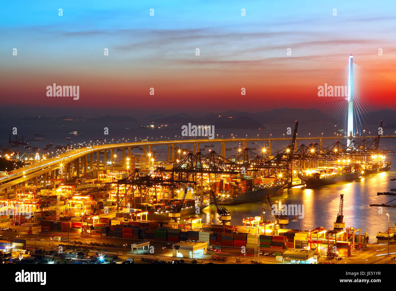 sunset in cargo container terminal Stock Photo - Alamy