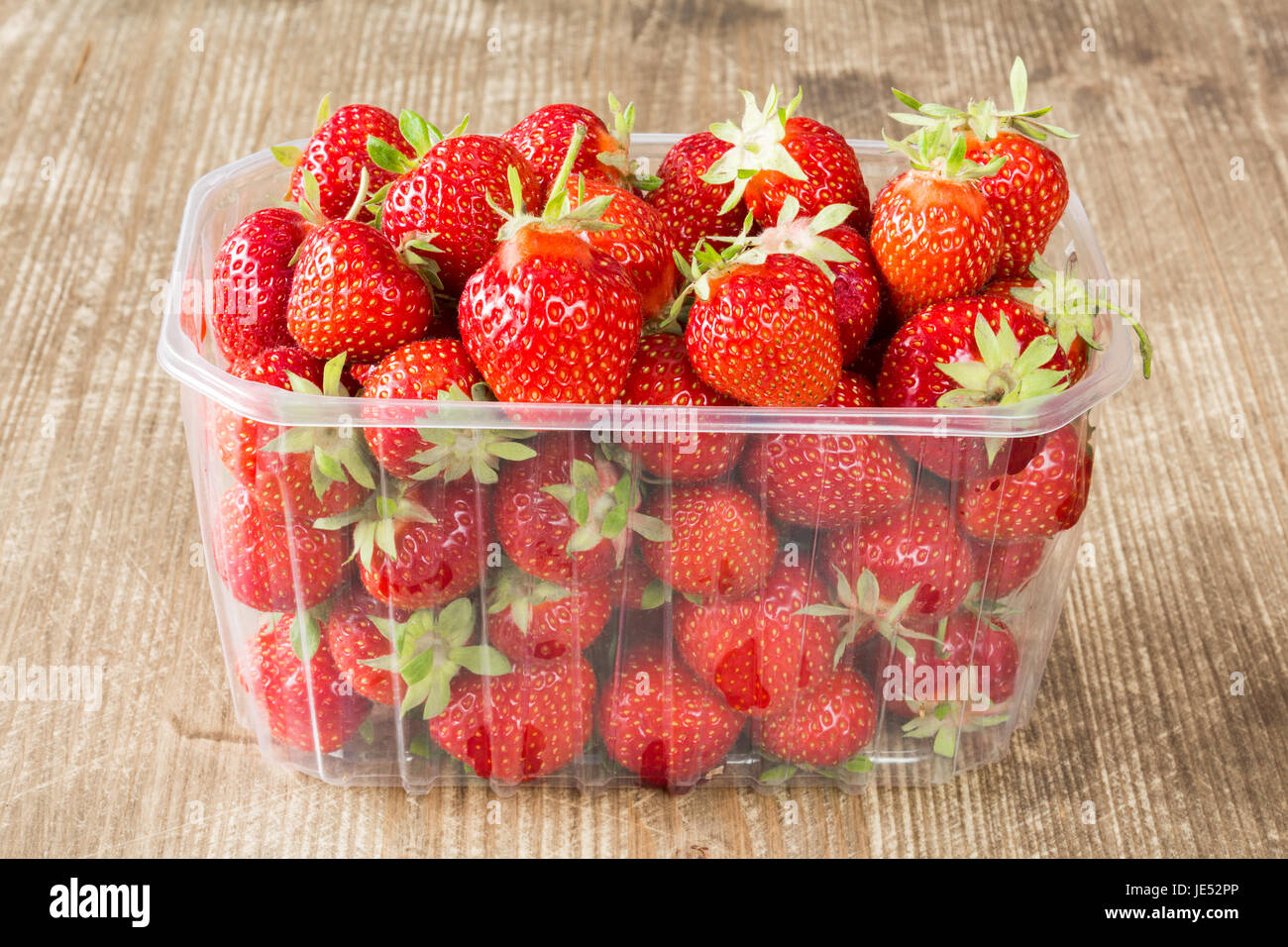 Symbol of summer, a punnet of delicious fresh strawberries on wooden ...