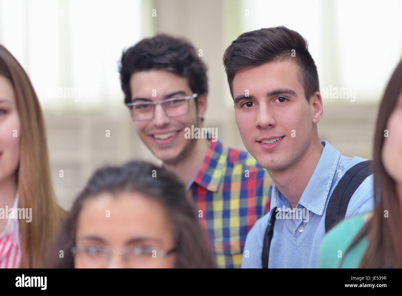 happy young teens group in school have fun an learning lessons Stock ...