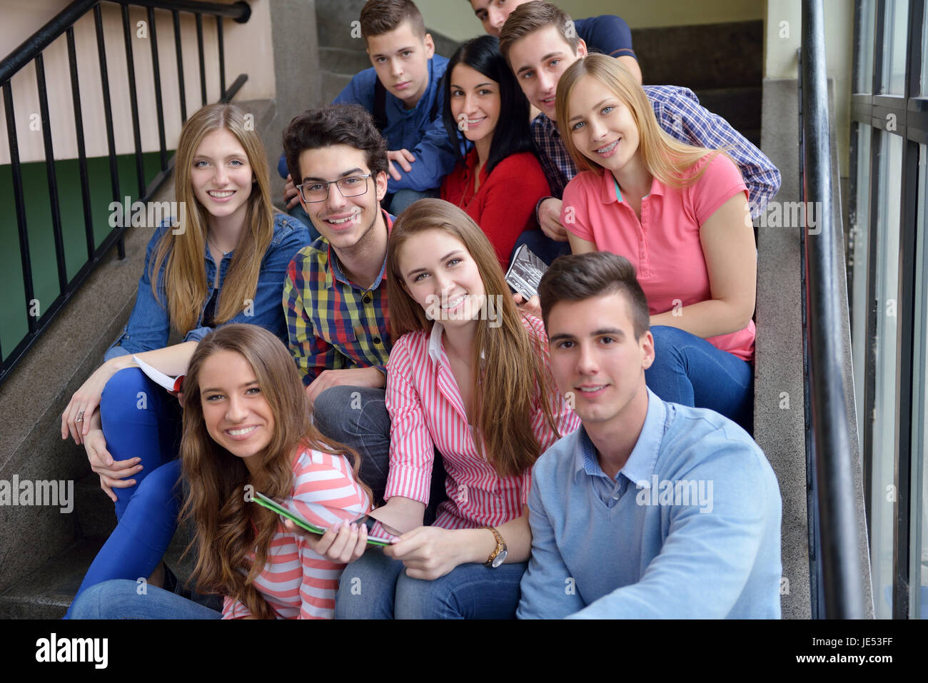 happy young teens group in school have fun an learning lessons Stock ...