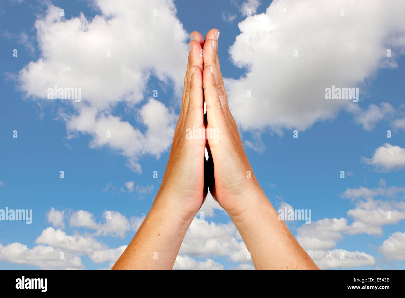 Hands in prayer position against a beautiful sky background Stock Photo ...