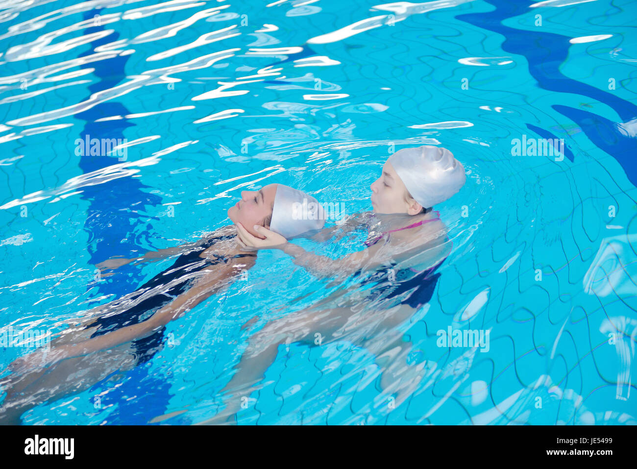 help and rescue action in swimming school at pool Stock Photo - Alamy