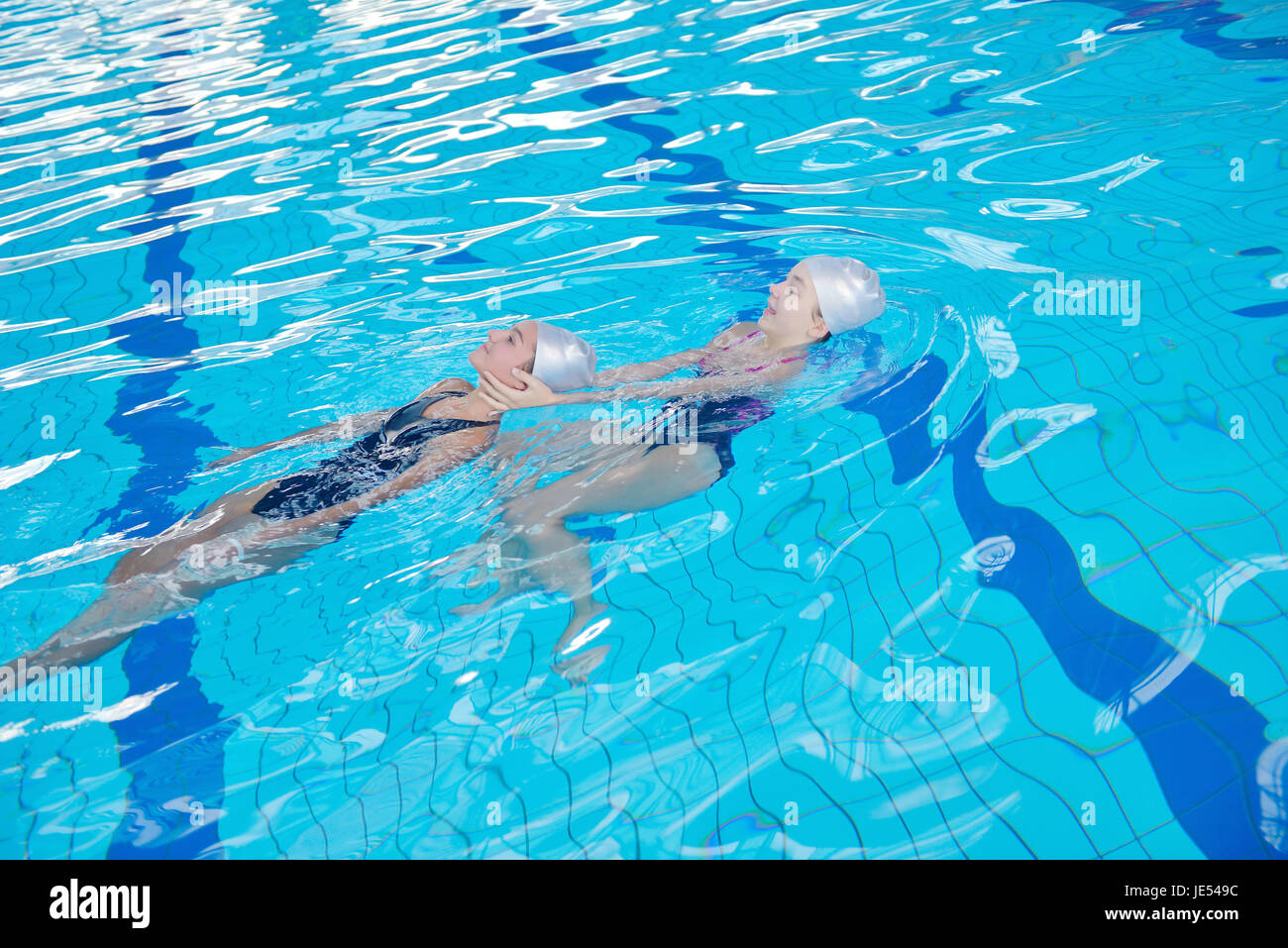 help and rescue action in swimming school at pool Stock Photo - Alamy