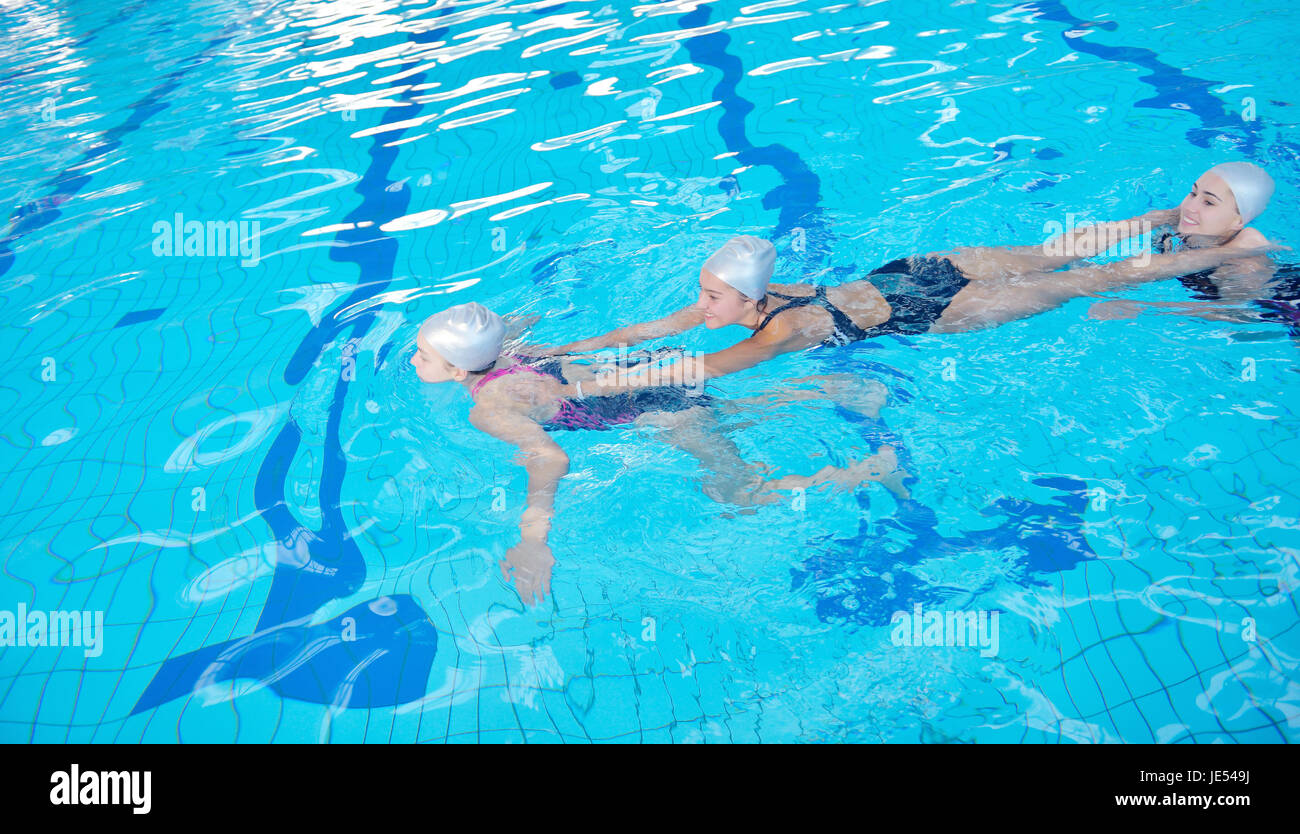 help and rescue action in swimming school at pool Stock Photo - Alamy
