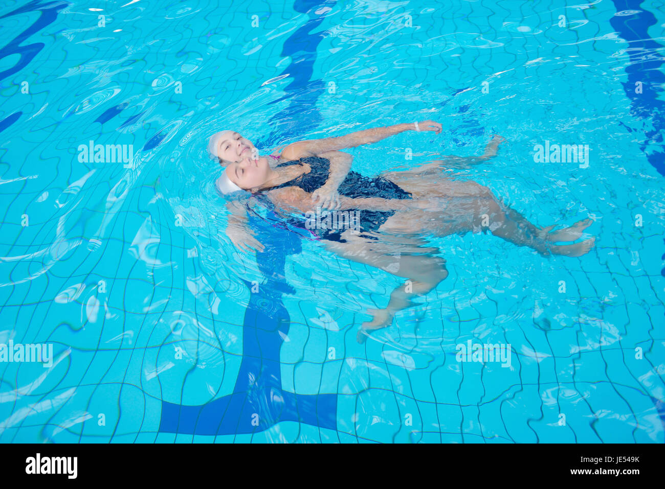 help and rescue action in swimming school at pool Stock Photo - Alamy