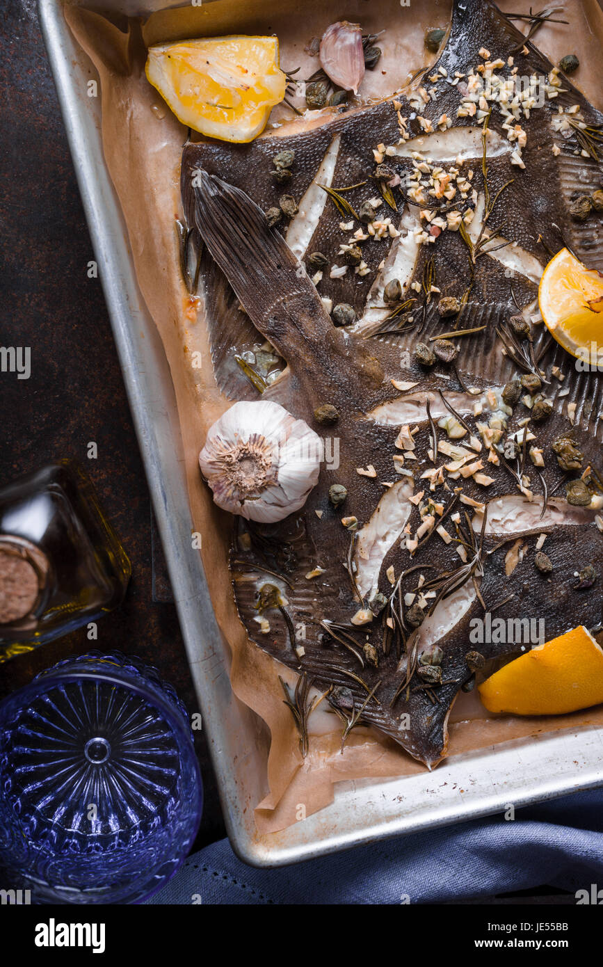 Baking tray with flounder and seasoning on stone vertical Stock Photo ...