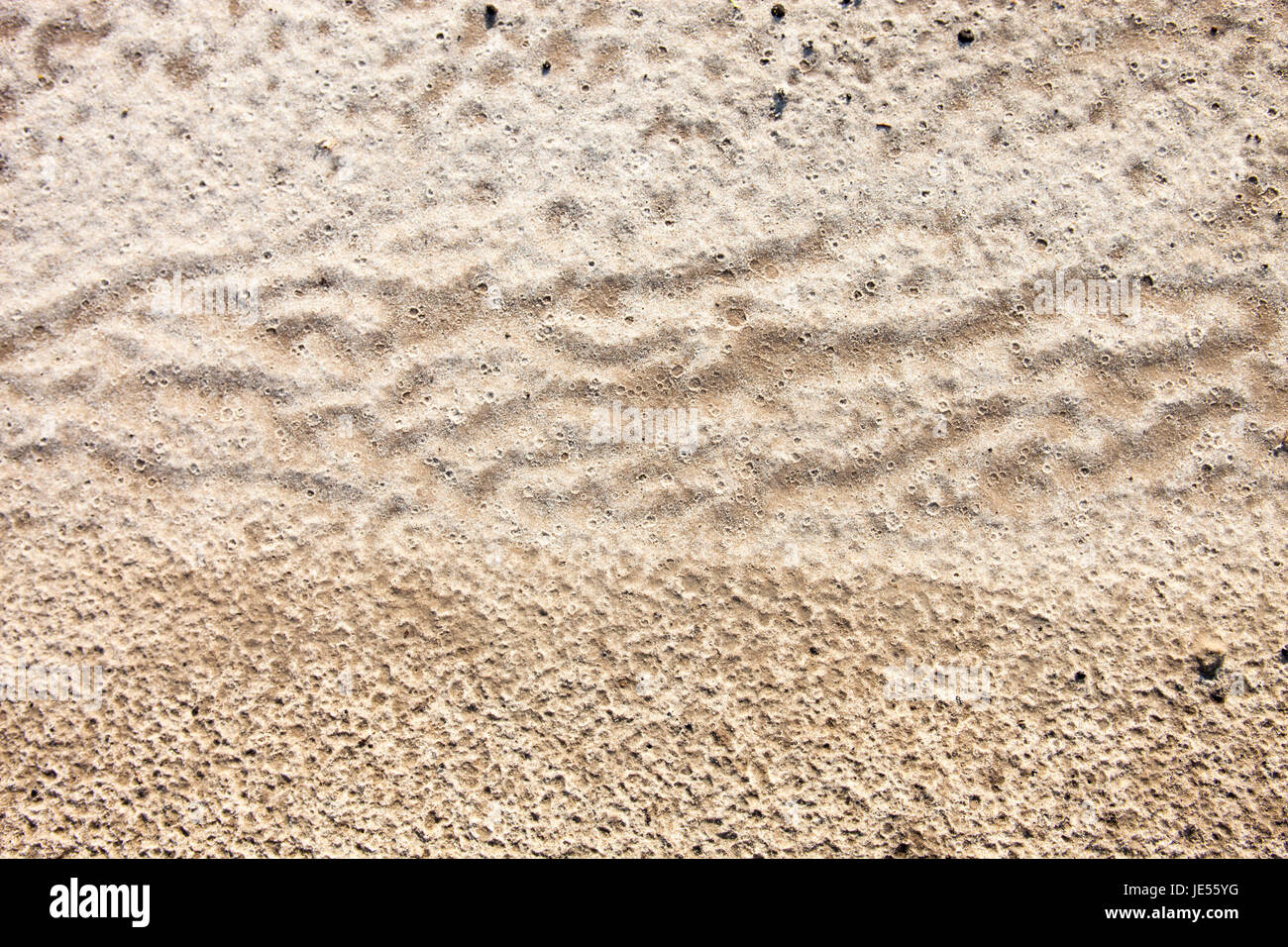 Sand surface after the rain with the visible traces of the raindrops ...