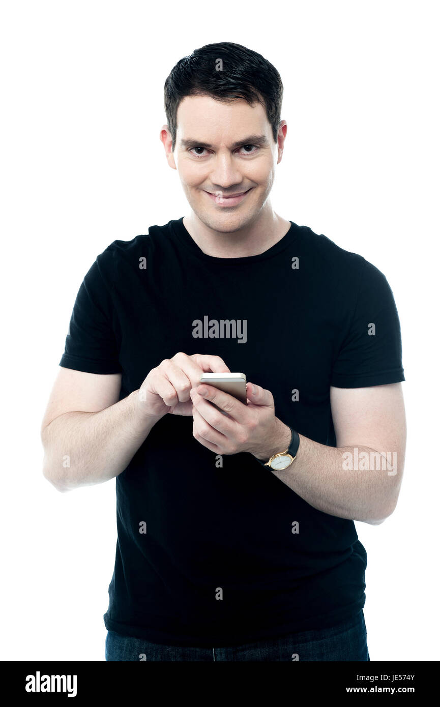Smiling man texting with smartphone isolated on white Stock Photo - Alamy