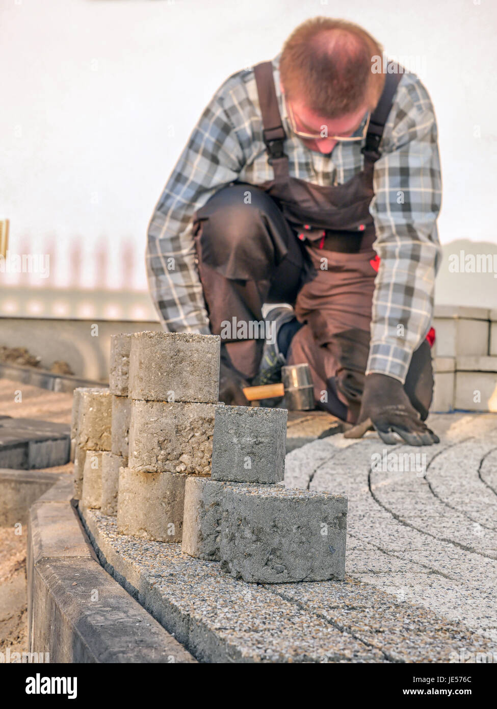 Paver laying pathway out of concrete pavement blocks Stock Photo - Alamy