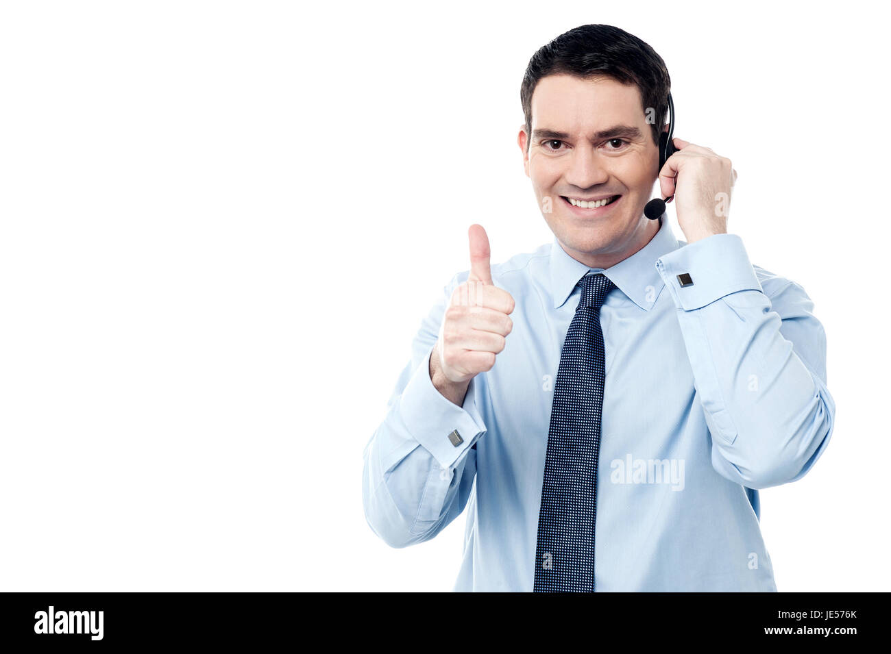 Smiling male call center agent posing with thumbs up sign Stock Photo ...