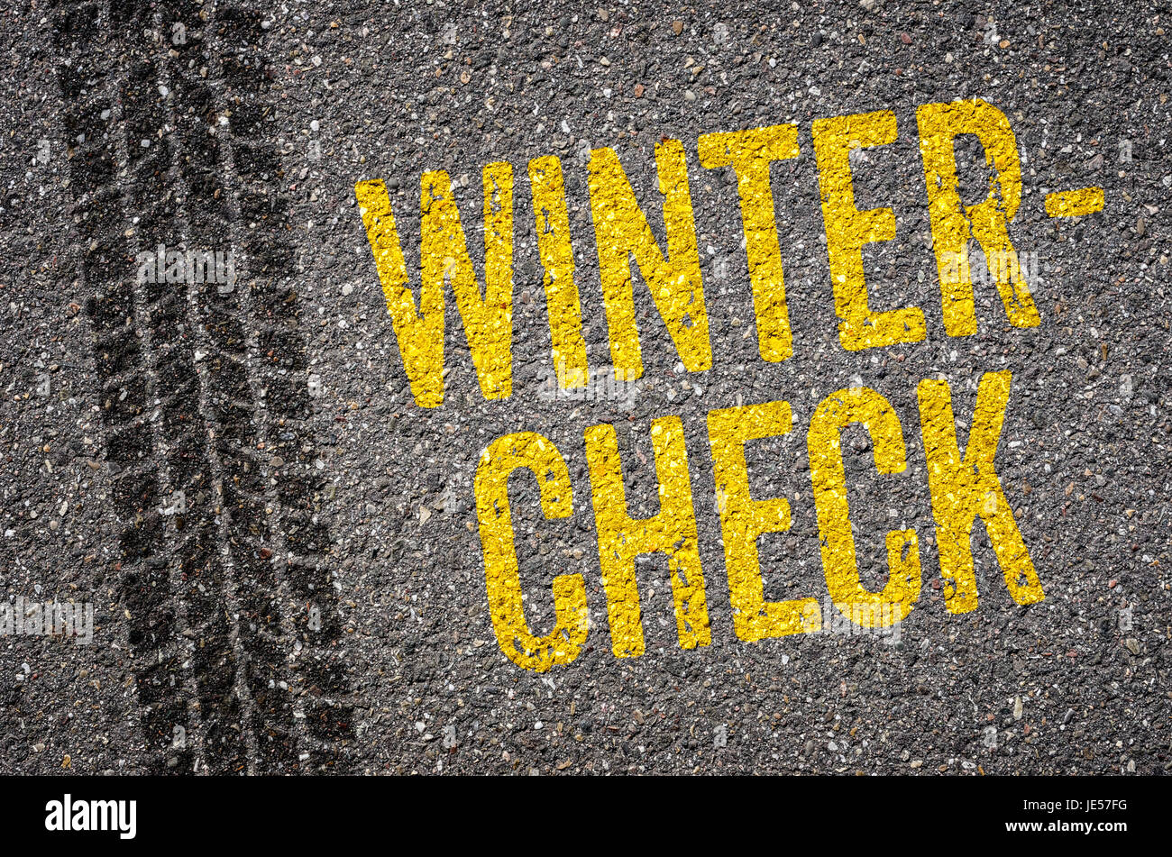 Asphalt mit dem Text Wintercheck Stock Photo - Alamy