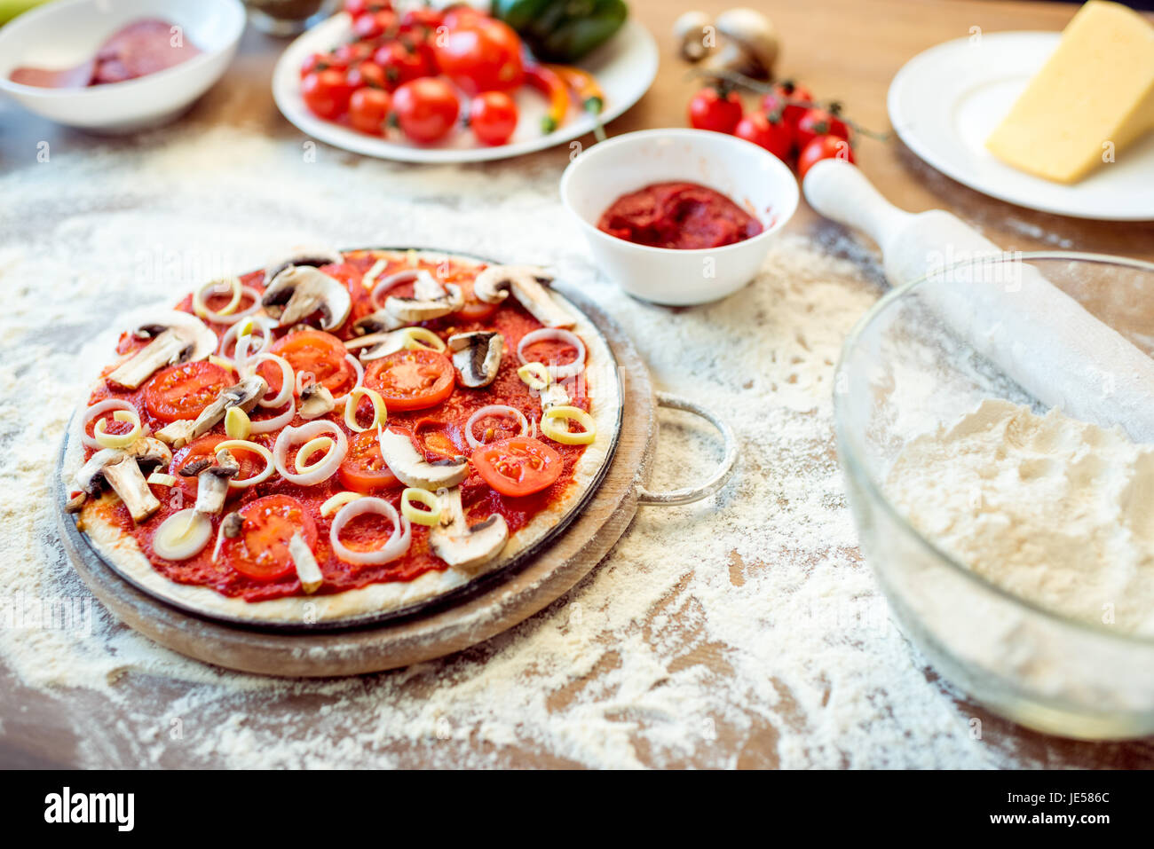 close up view of pizza and various ingredients on table Stock Photo - Alamy
