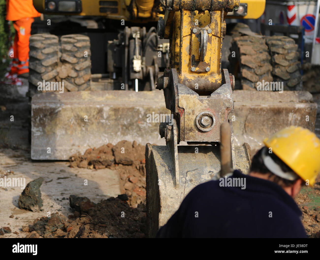 construction site with the digger and the worker inside the digging for ...