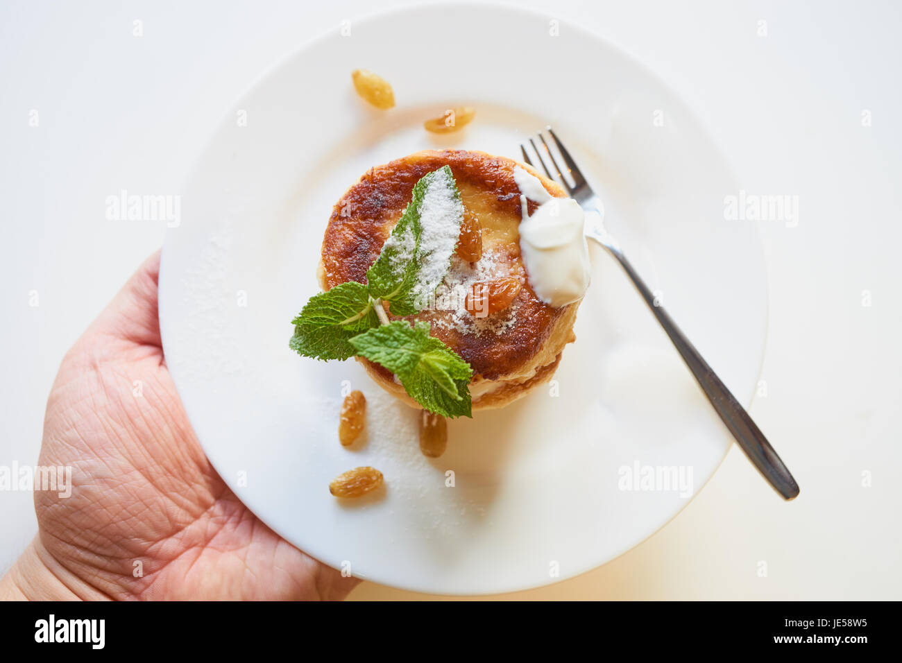 hand with a plate full of pancakes. god's food. delicious and healthy ...