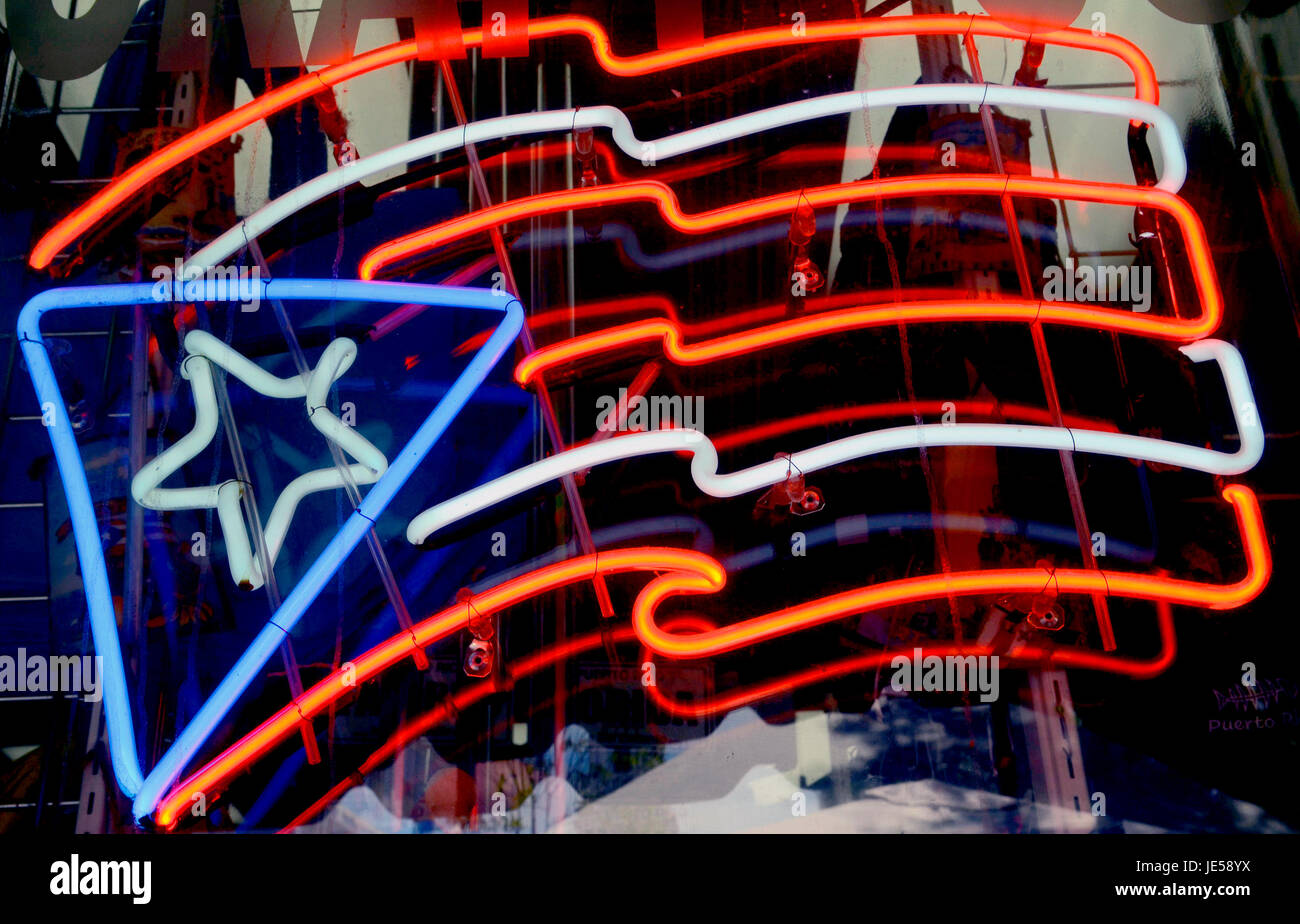 A neon Puerto Rican flag flashes from a store window in Ponce, Puerto ...