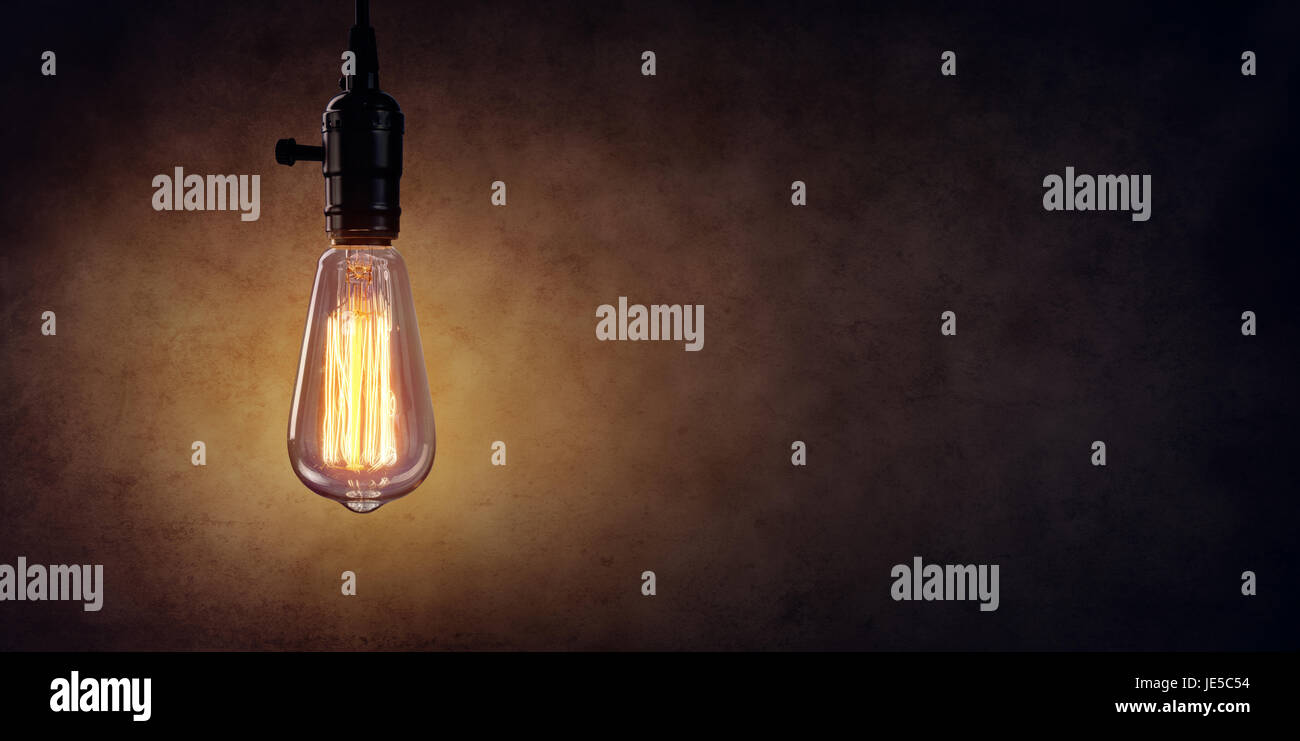 Vintage Hanging Light Bulb Over Dark Wall Stock Photo - Alamy