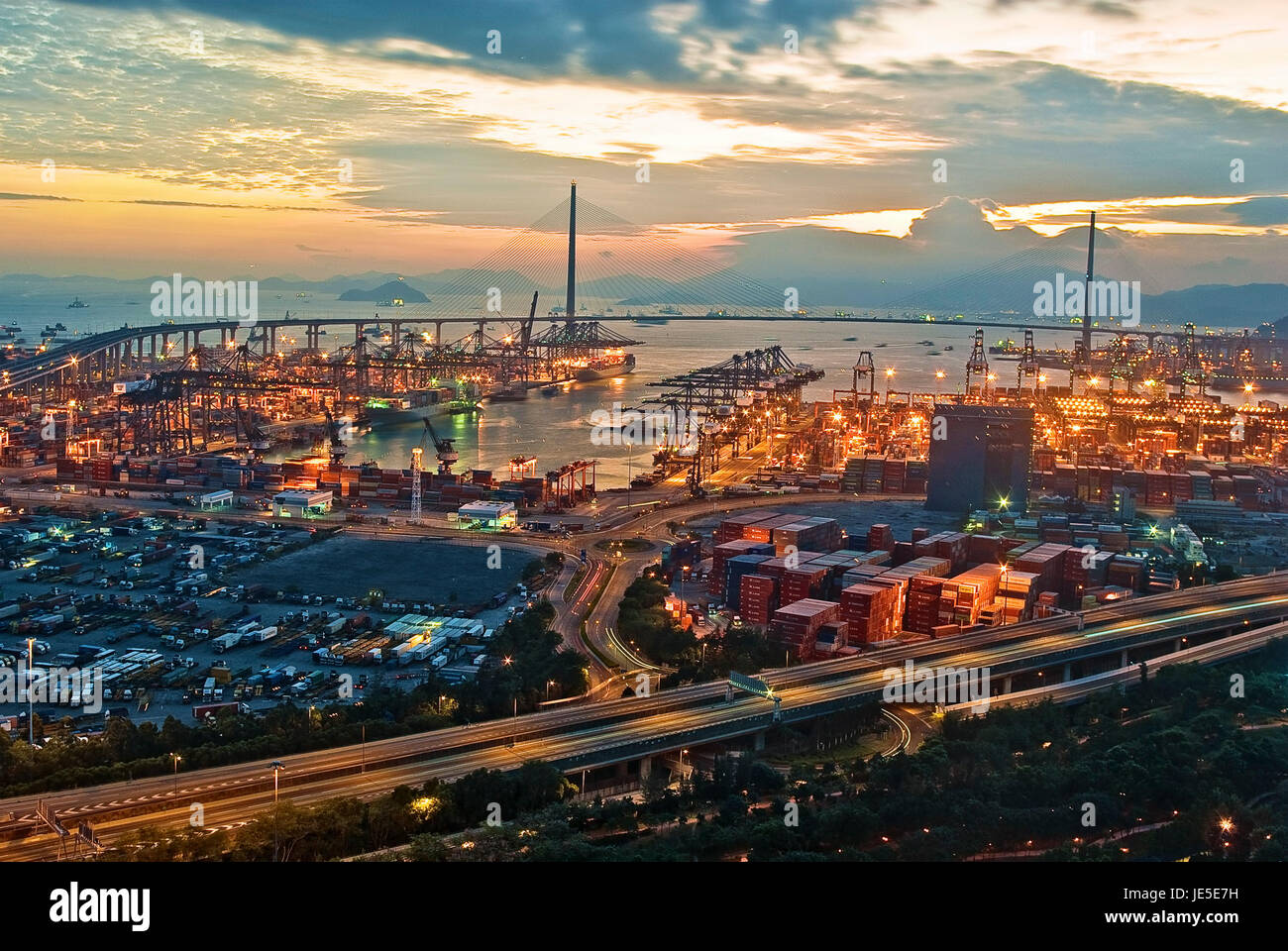 Port warehouse with cargoes and containers at night Stock Photo - Alamy