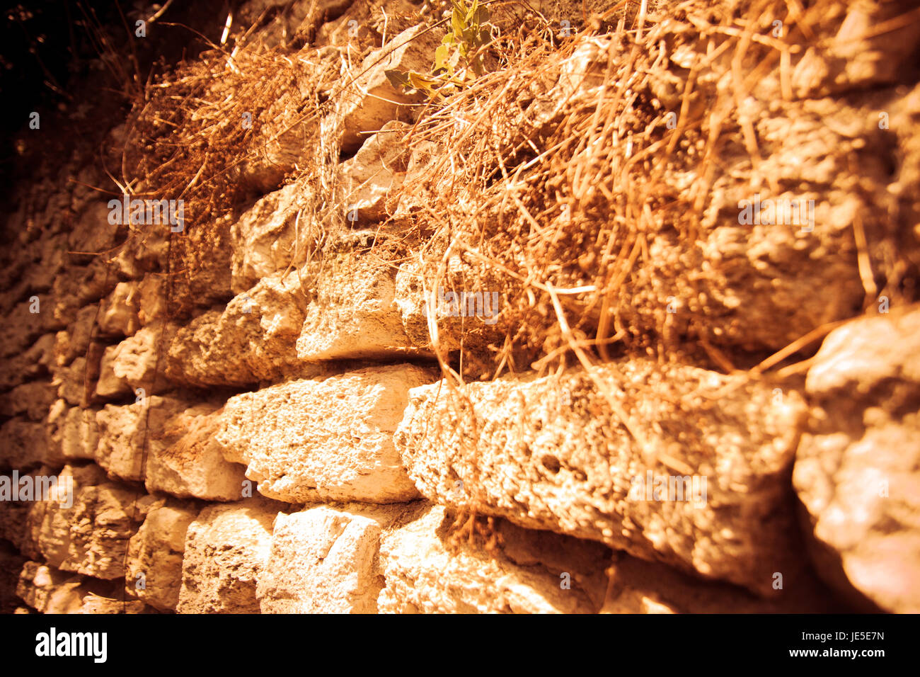 Old yellow stone wall texture background closeup Stock Photo - Alamy