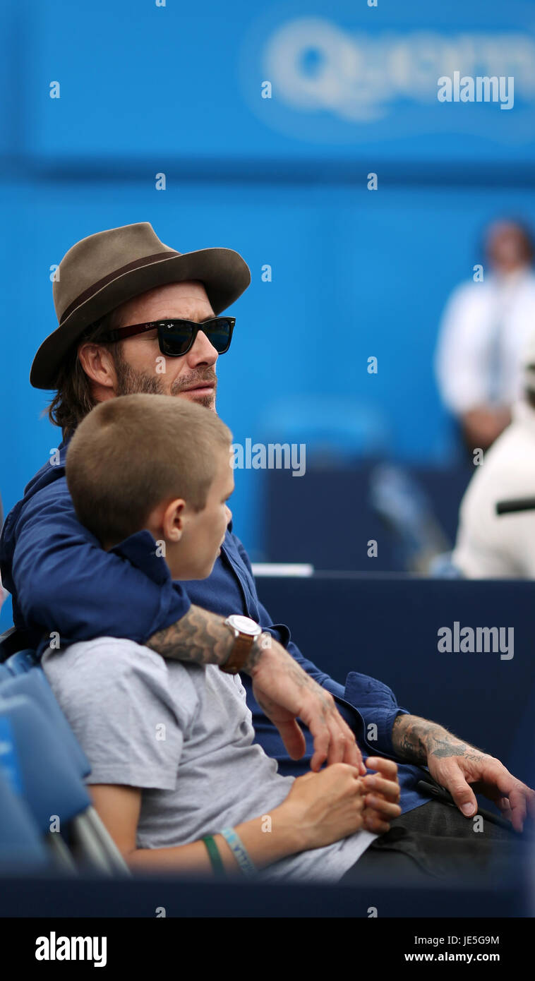 David Beckham watches the action with his son Romeo during day four of ...