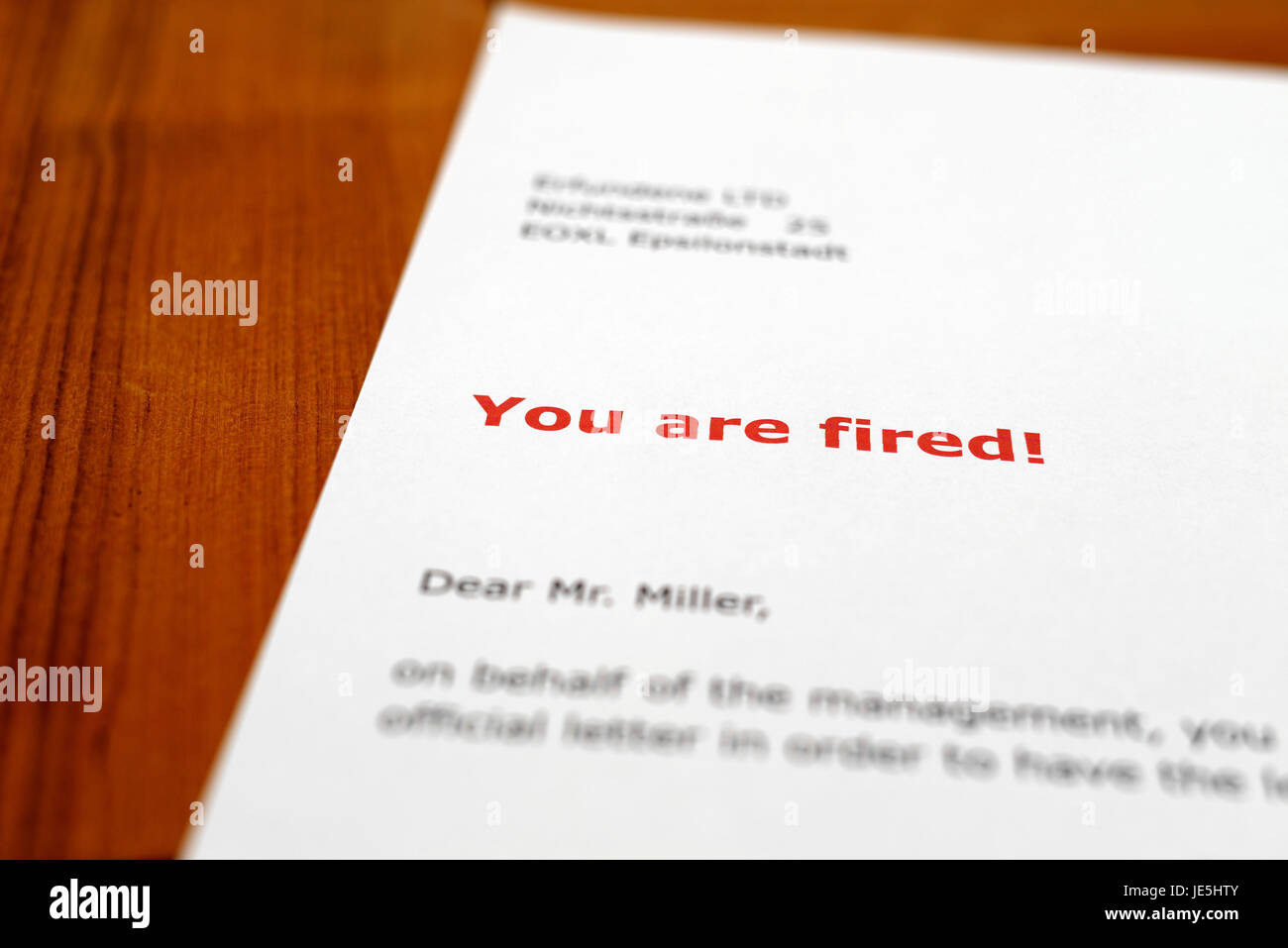 A letter on a wooden table - you are fired Stock Photo - Alamy