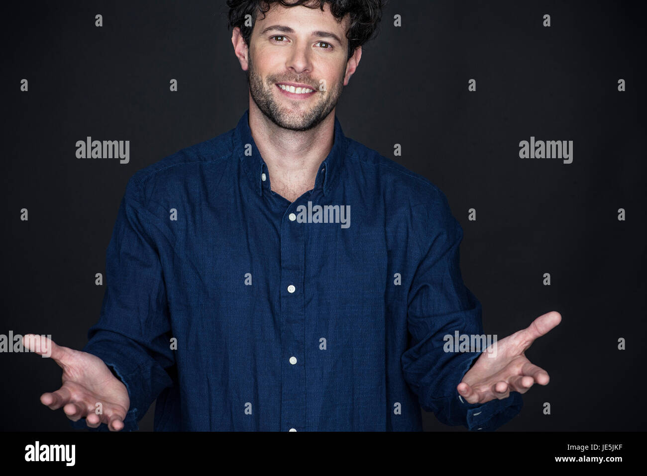 Man holding hands out in apologetic gesture Stock Photo - Alamy
