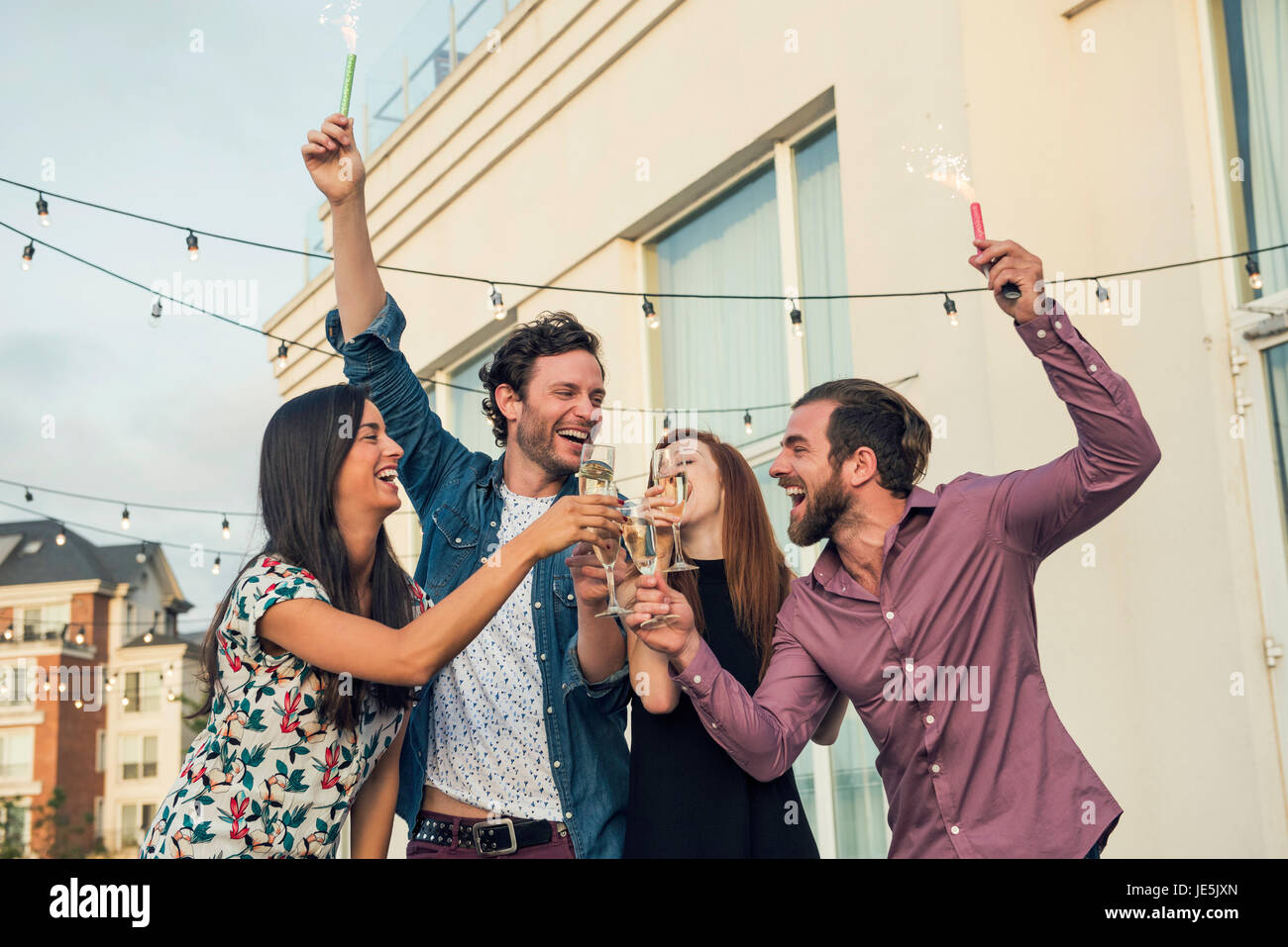 Friends celebrating with champagne outdoors Stock Photo - Alamy