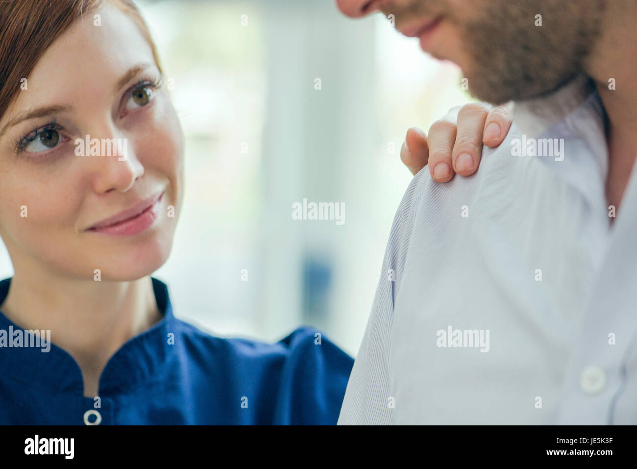 Healthcare worker reassuring patient Stock Photo - Alamy