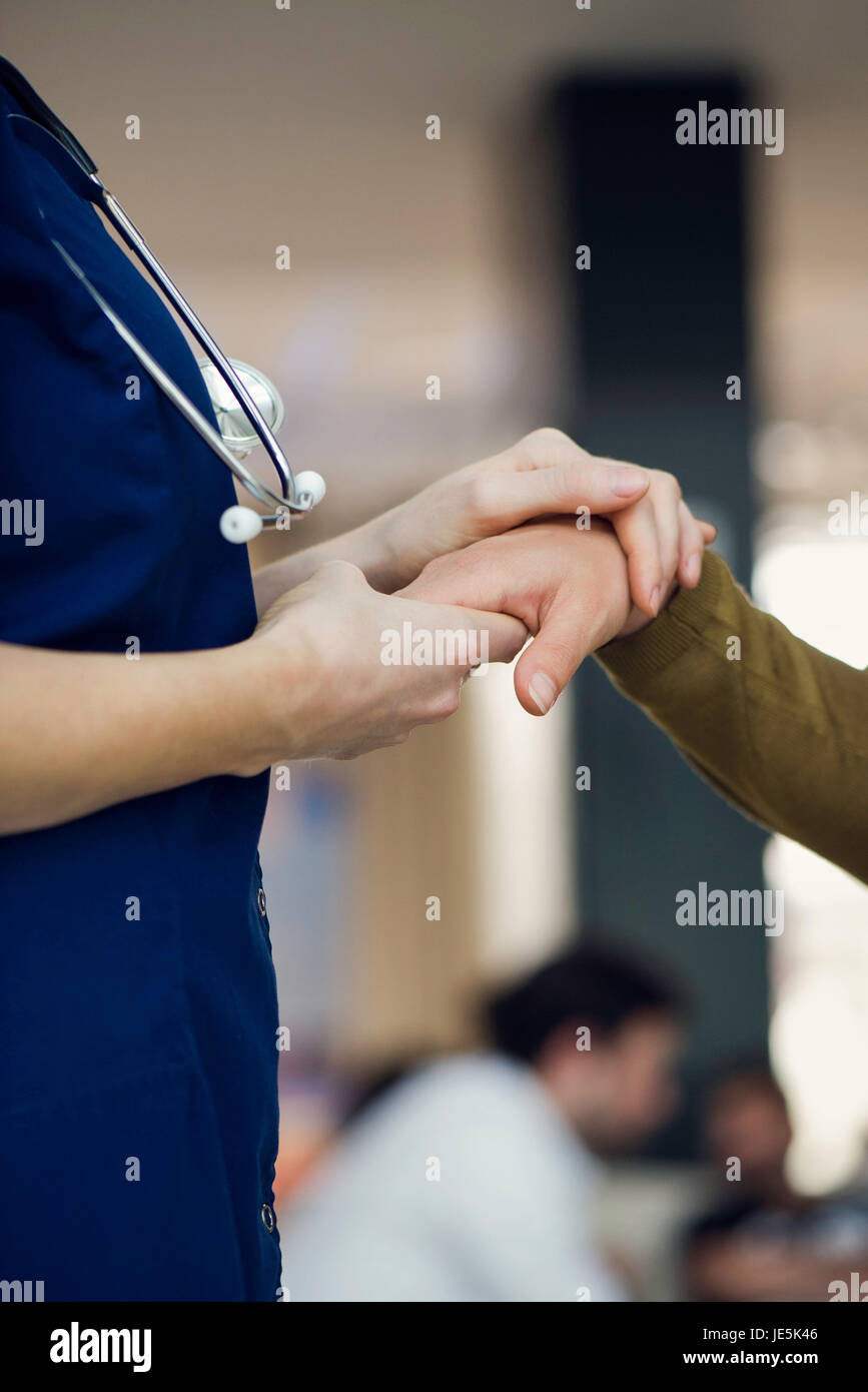 Doctor holding patient's hand Stock Photo - Alamy
