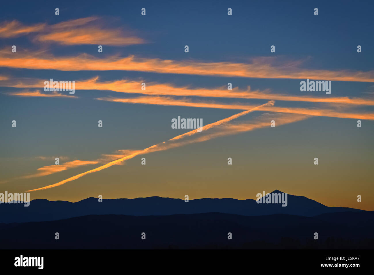 Orange contrails on the sky during the sunset Stock Photo - Alamy