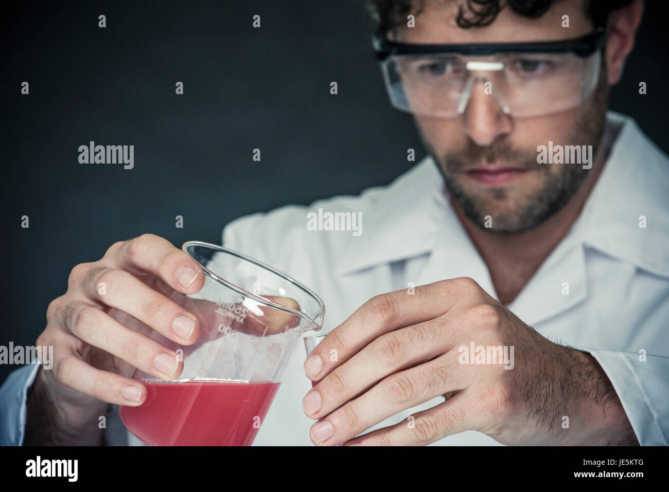 Scientist pouring chemicals in laboratory hi-res stock photography and ...