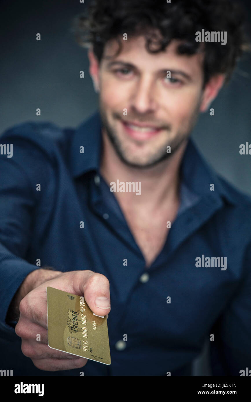 Man holding out credit card Stock Photo - Alamy