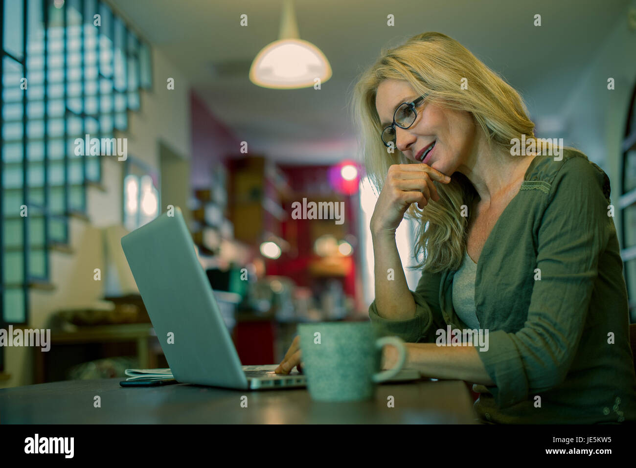 Woman using laptop computer at home Stock Photo - Alamy