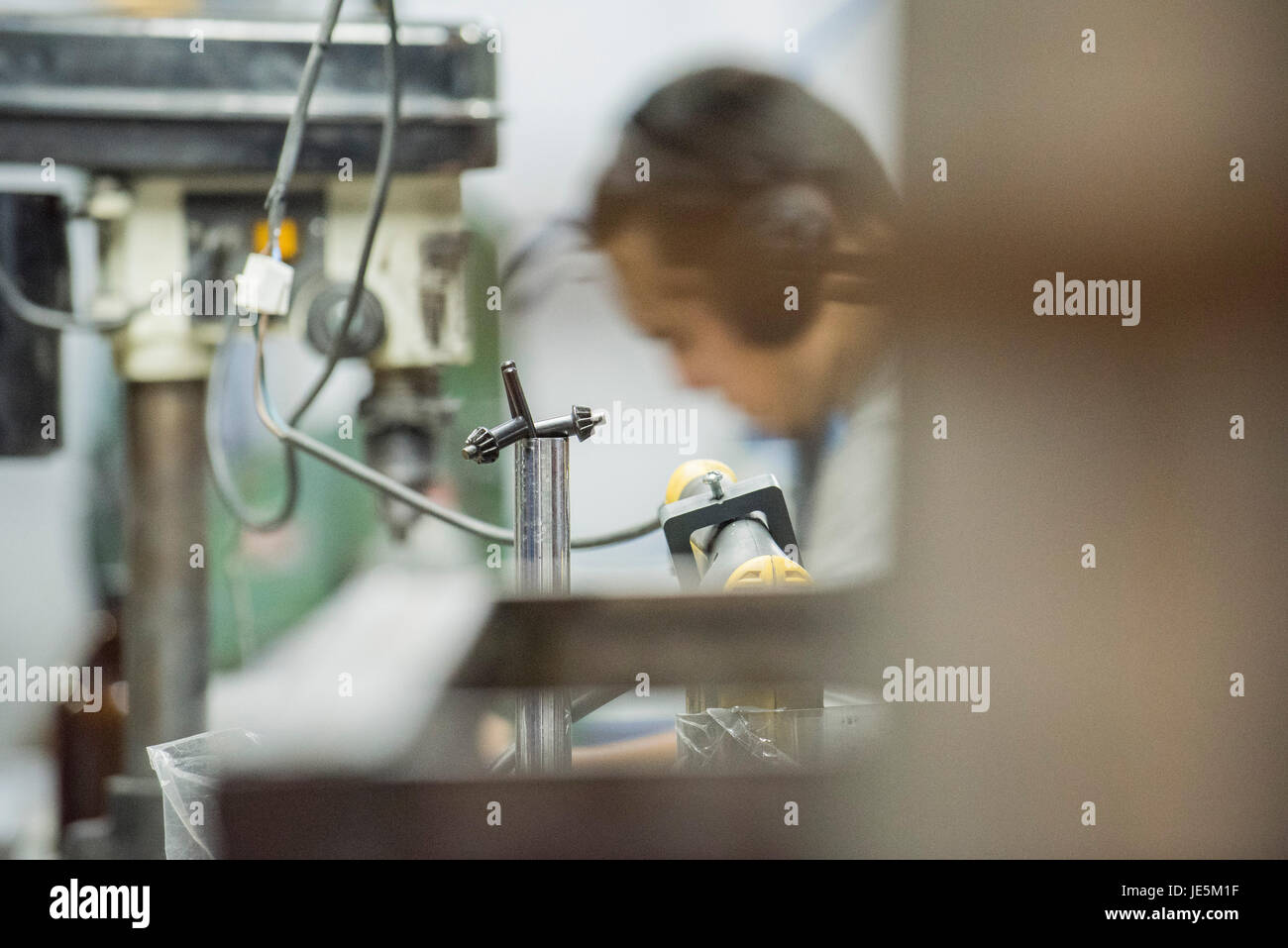 Machinist at work in factory Stock Photo - Alamy