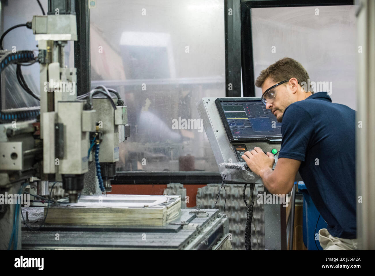 Machinist working in factory Stock Photo - Alamy