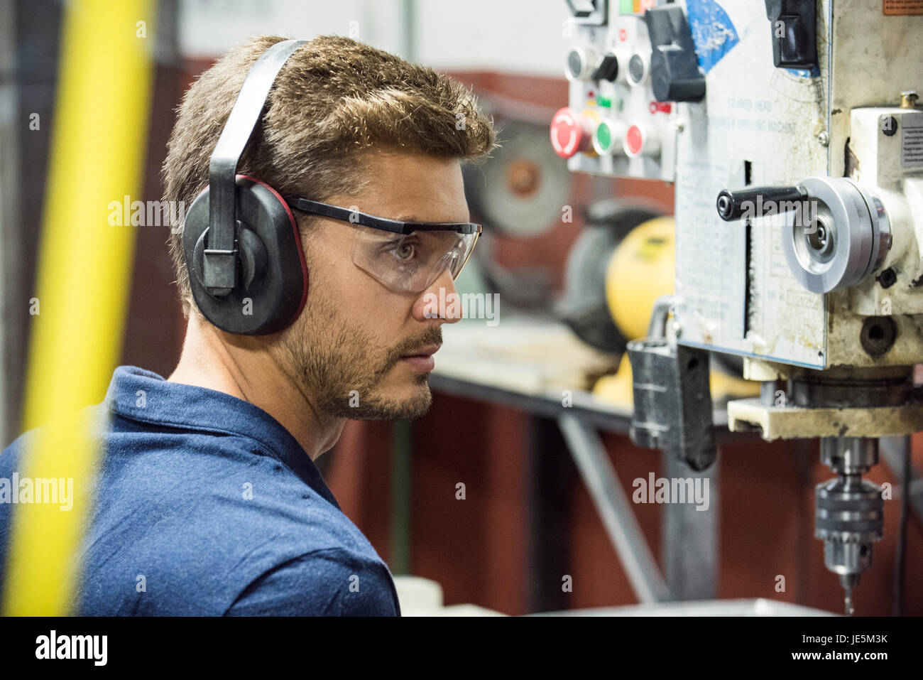 Machinist working in factory Stock Photo - Alamy