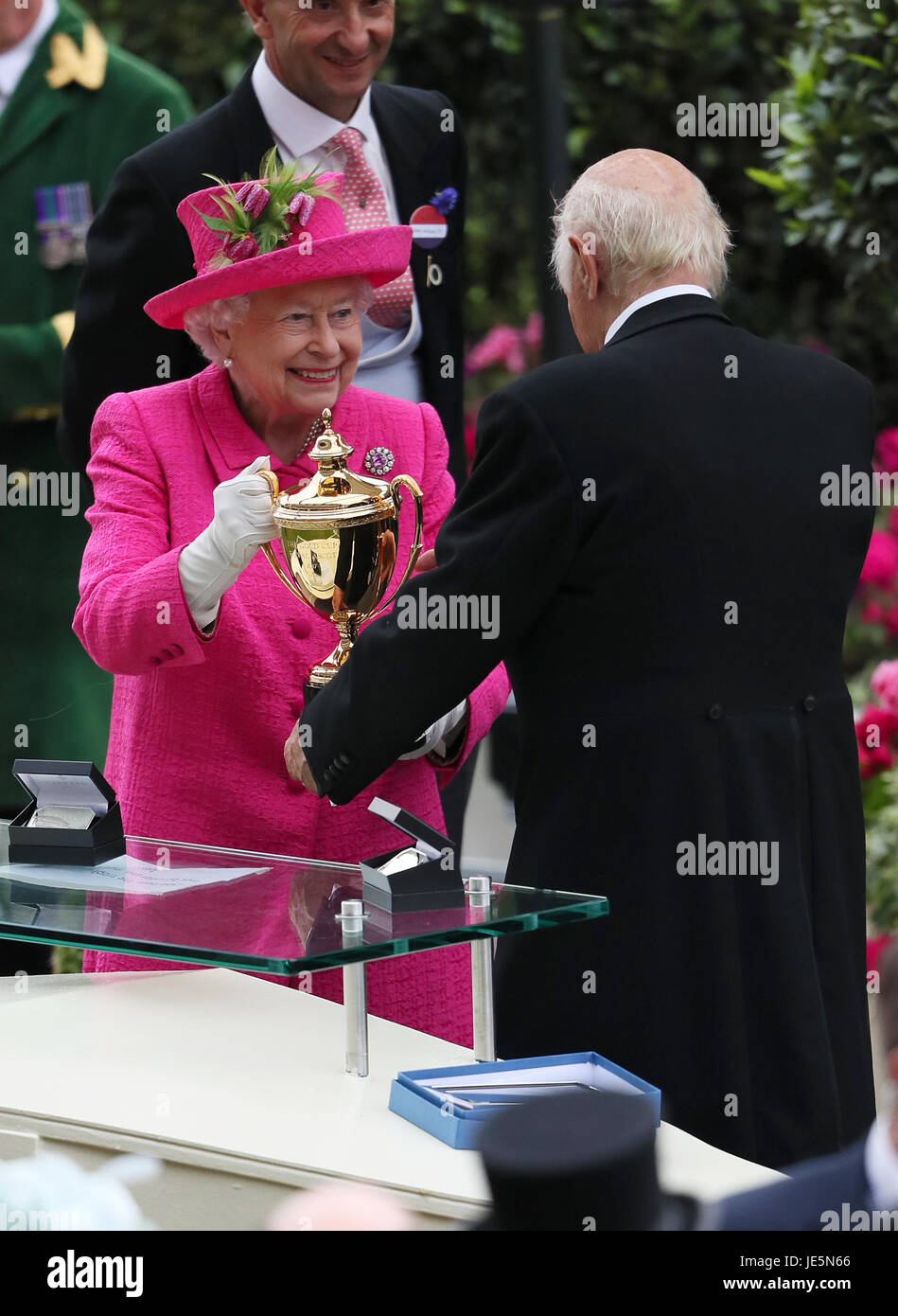 Queen Elizabeth II holds the trophy to be presented to the winner of ...