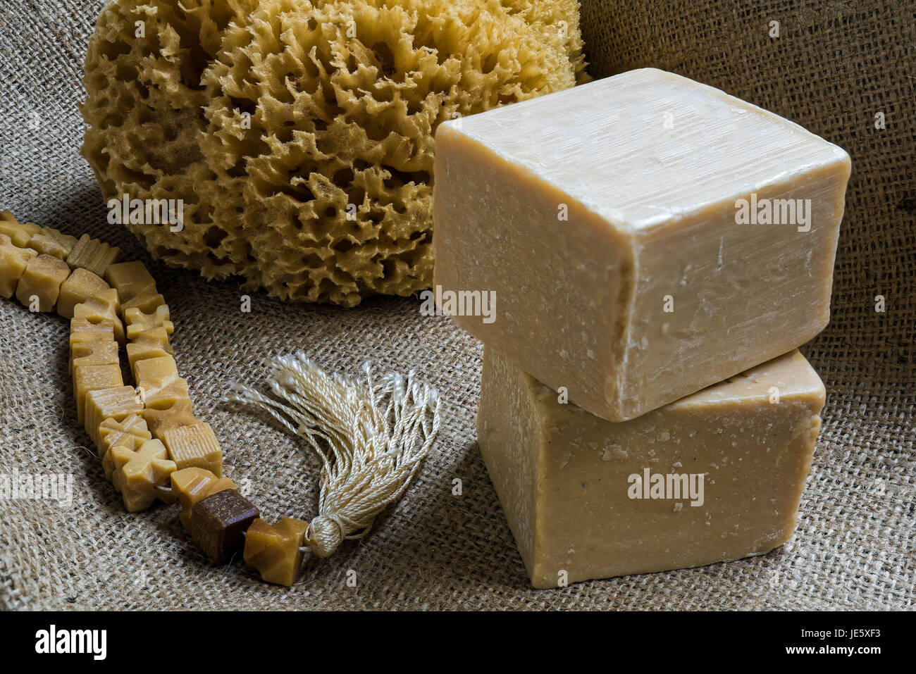 Handmade olive oil soaps together with a natural sea sponge and a ...