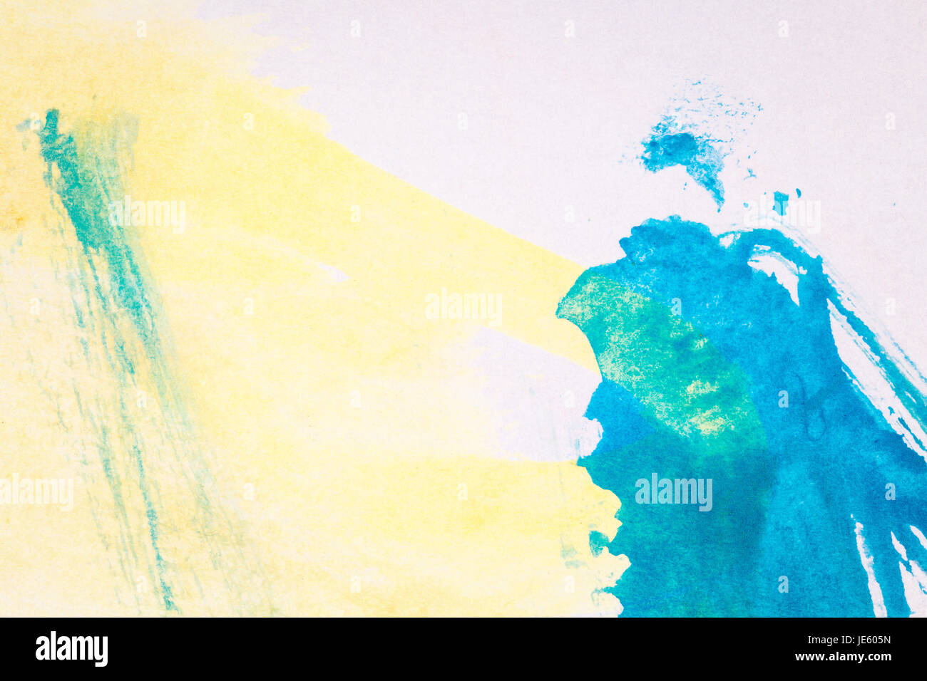 Macro shot of abstract hand drawn blue and yellow watercolor paints ...