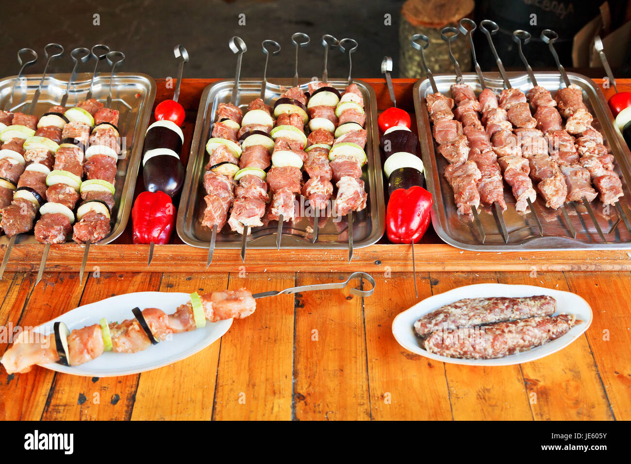 Crimean tatar cuisine - skewers of raw lamb shish kebabs and vegetables ...