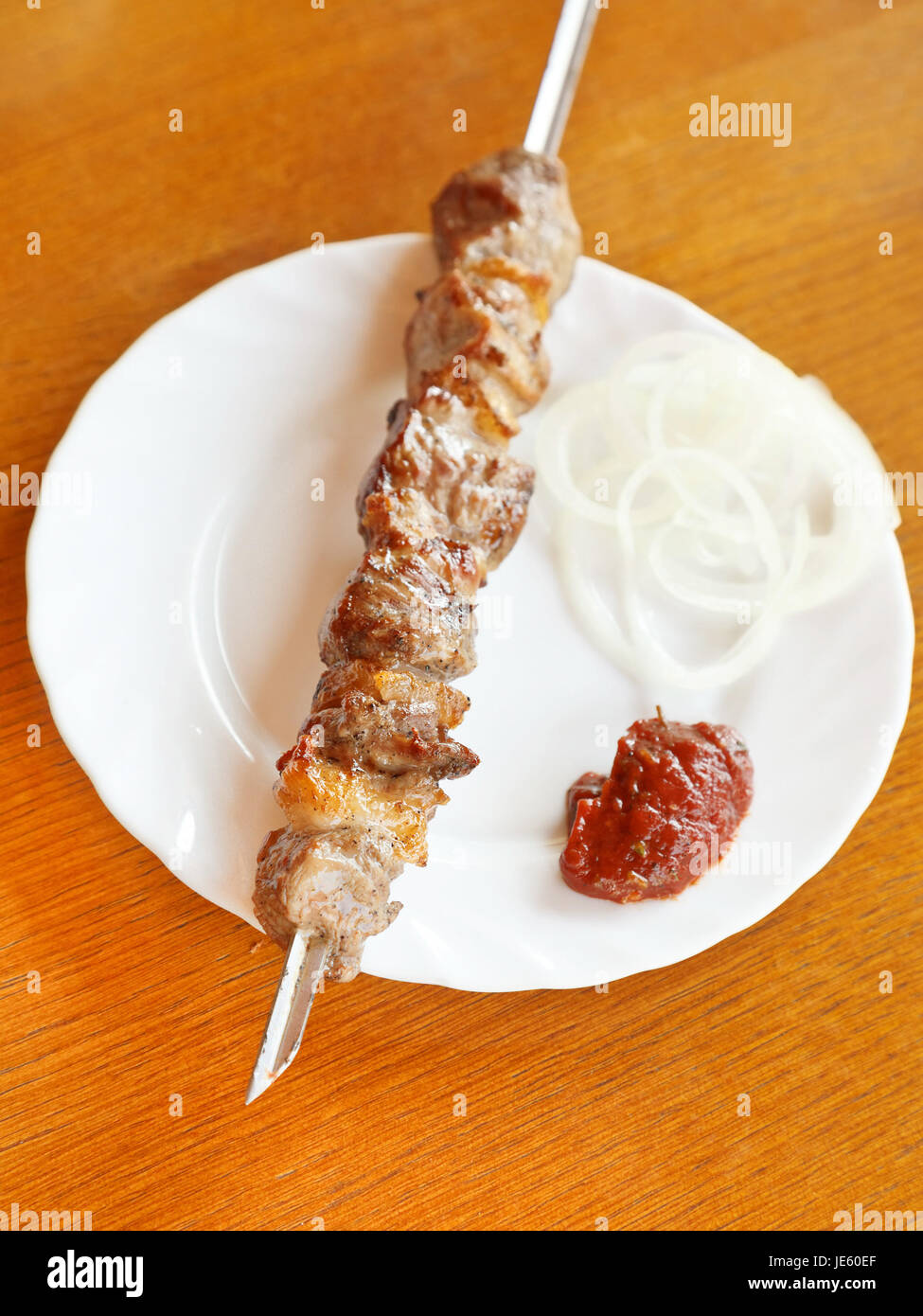 Crimean tatar cuisine - skewer of lamb shish kebab on white plate Stock ...