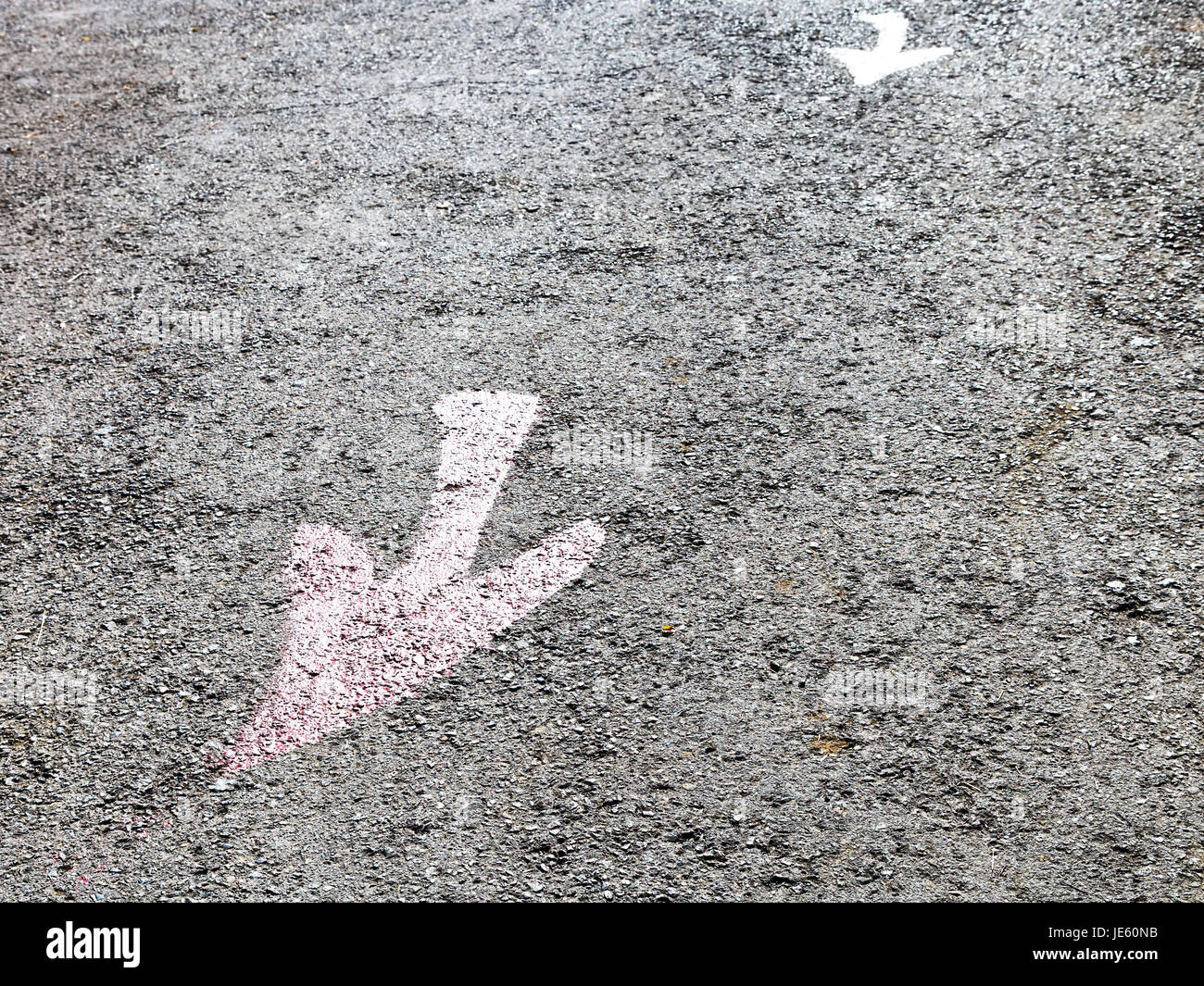 red arrows - road pointers on pavement Stock Photo - Alamy