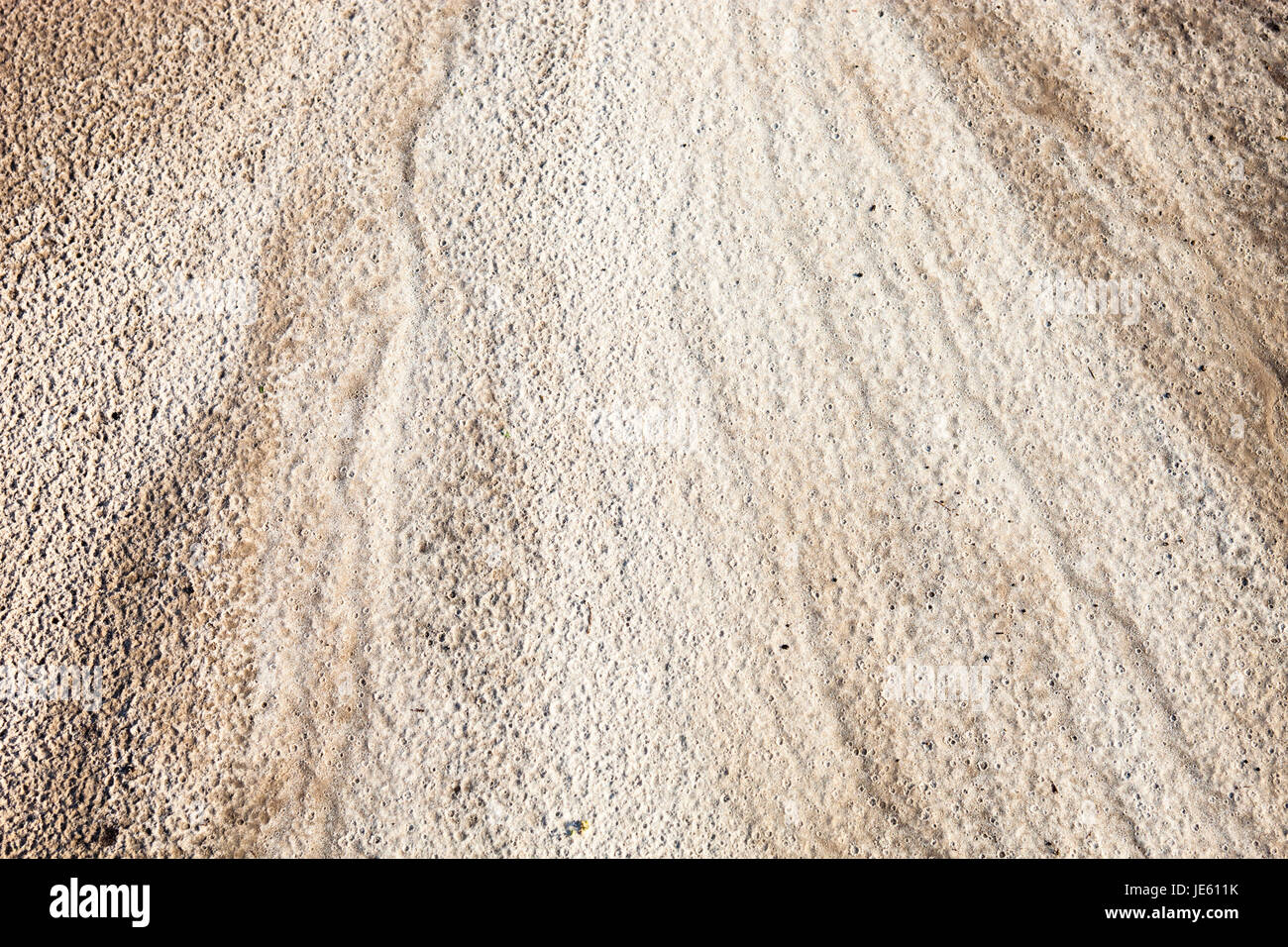 Sand surface after the rain with the visible traces of the raindrops ...