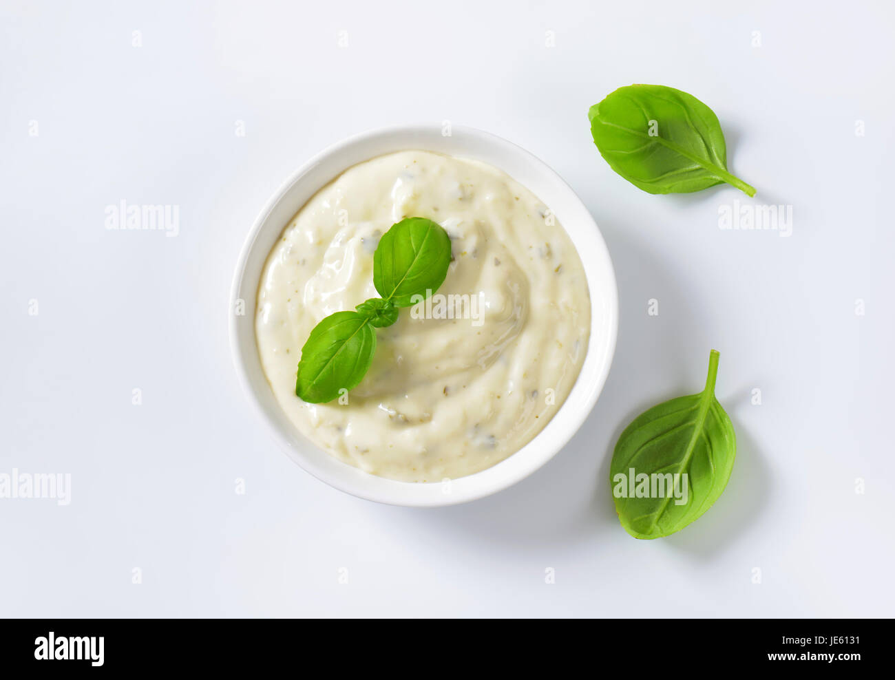 Creamy salad dressing made of mayonnaise, buttermilk, garlic, herbs ...