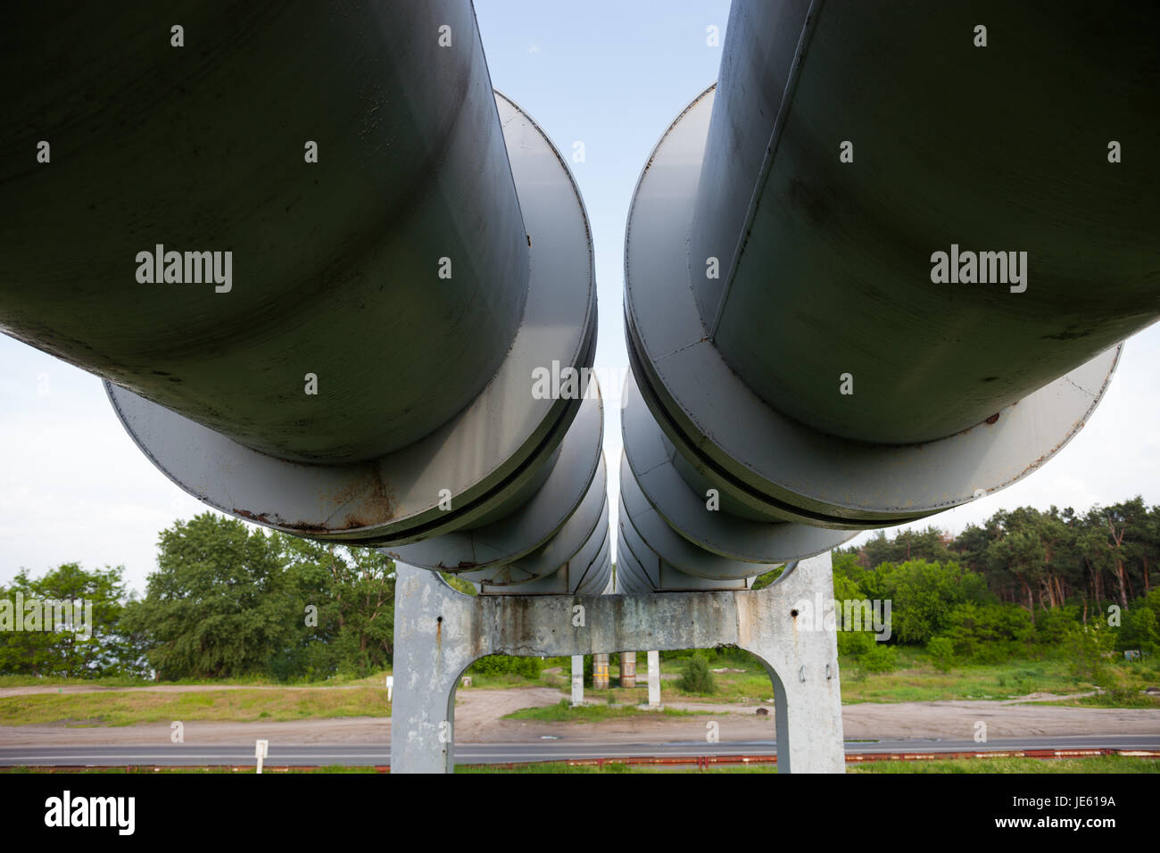 Elevated section of the pipelines above the road. Closeup Stock Photo ...