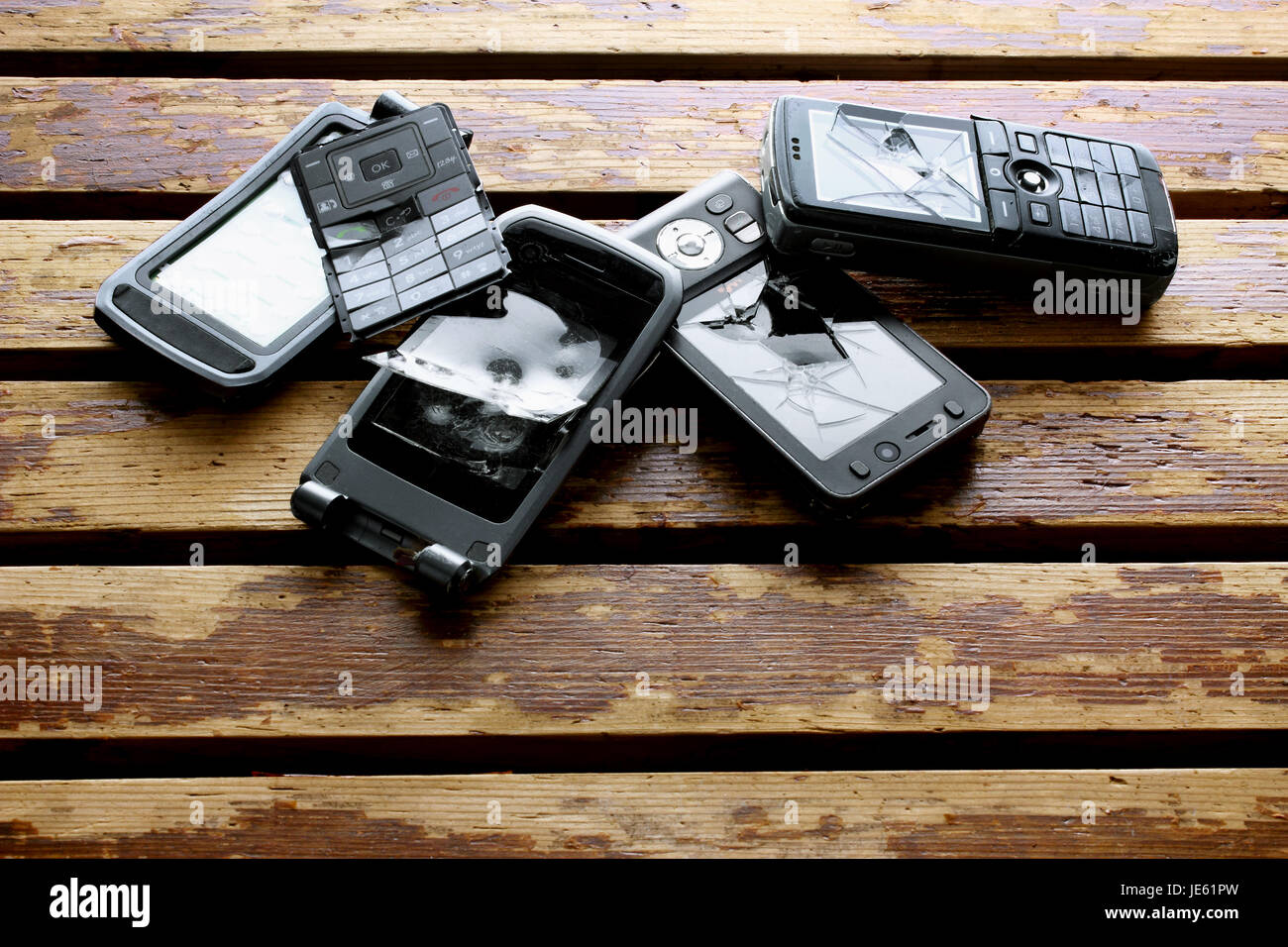 Broken Mobile Phones on Wooden Background Stock Photo - Alamy