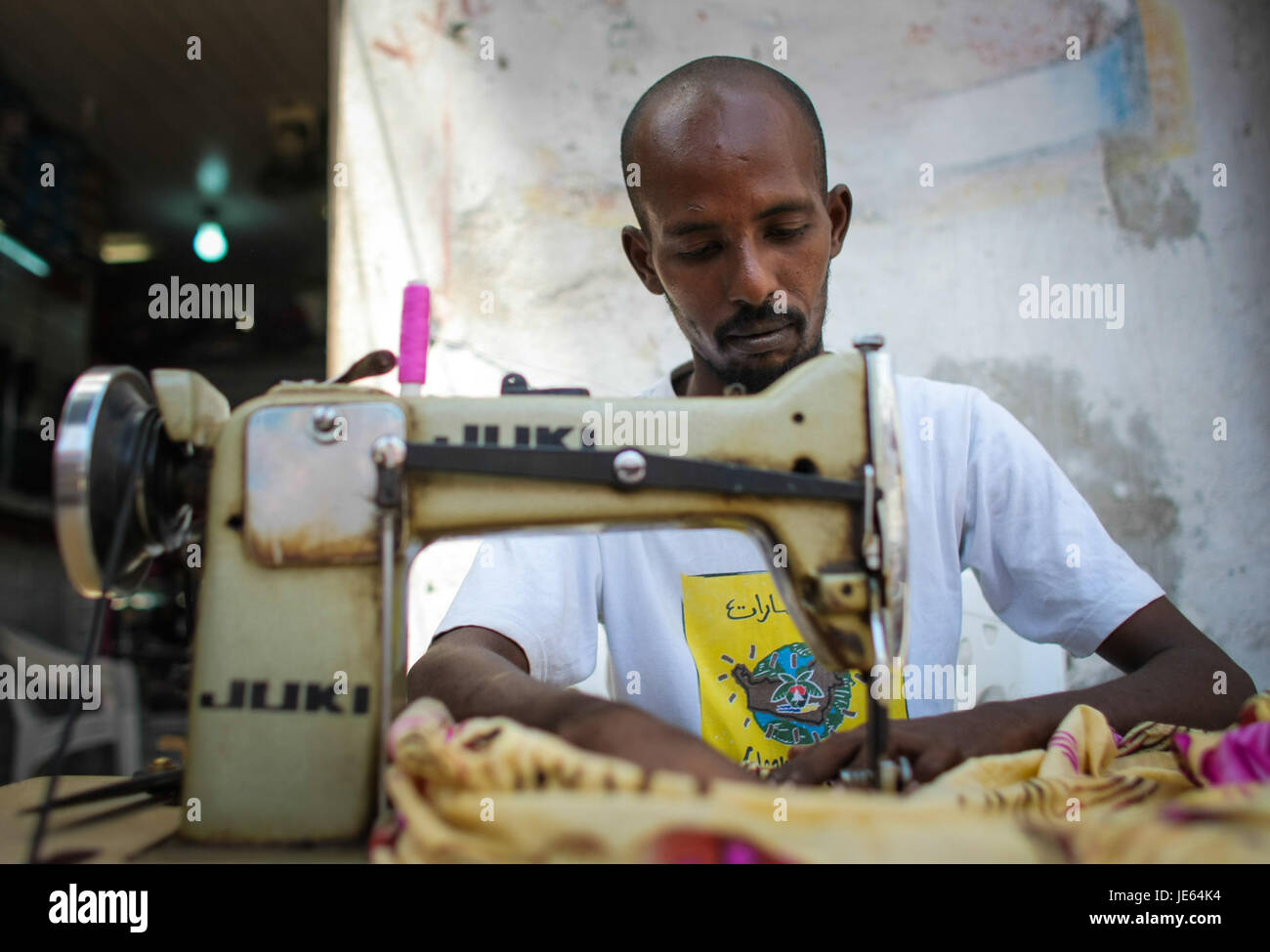The photograph depicts daily life in Mogadishu, Somalia, focusing on ...